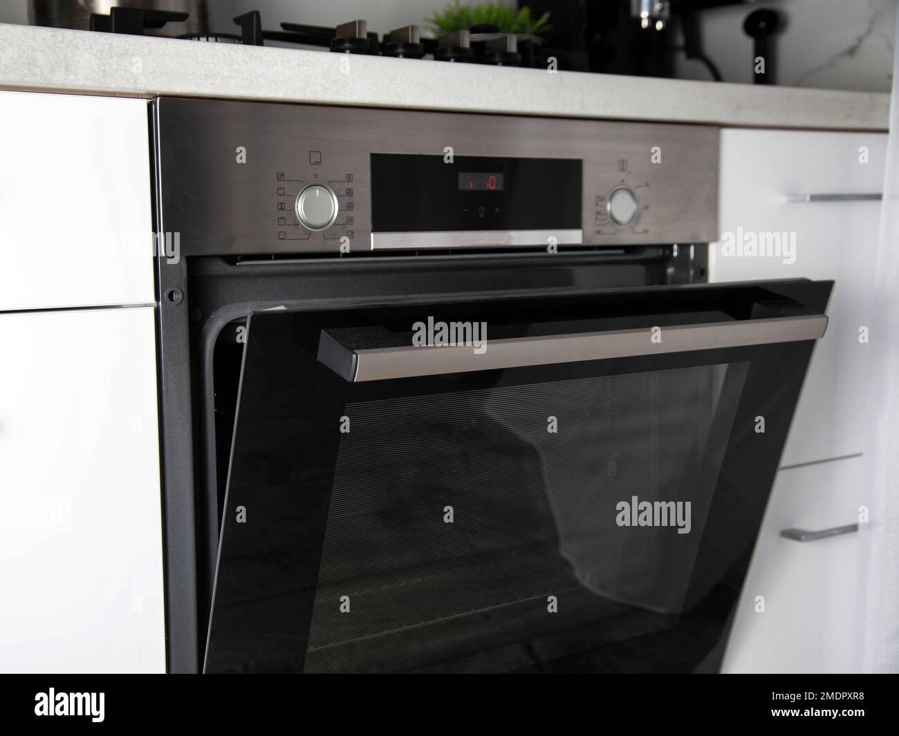 Black modern electric oven built into a white kitchen. Multifunction ...