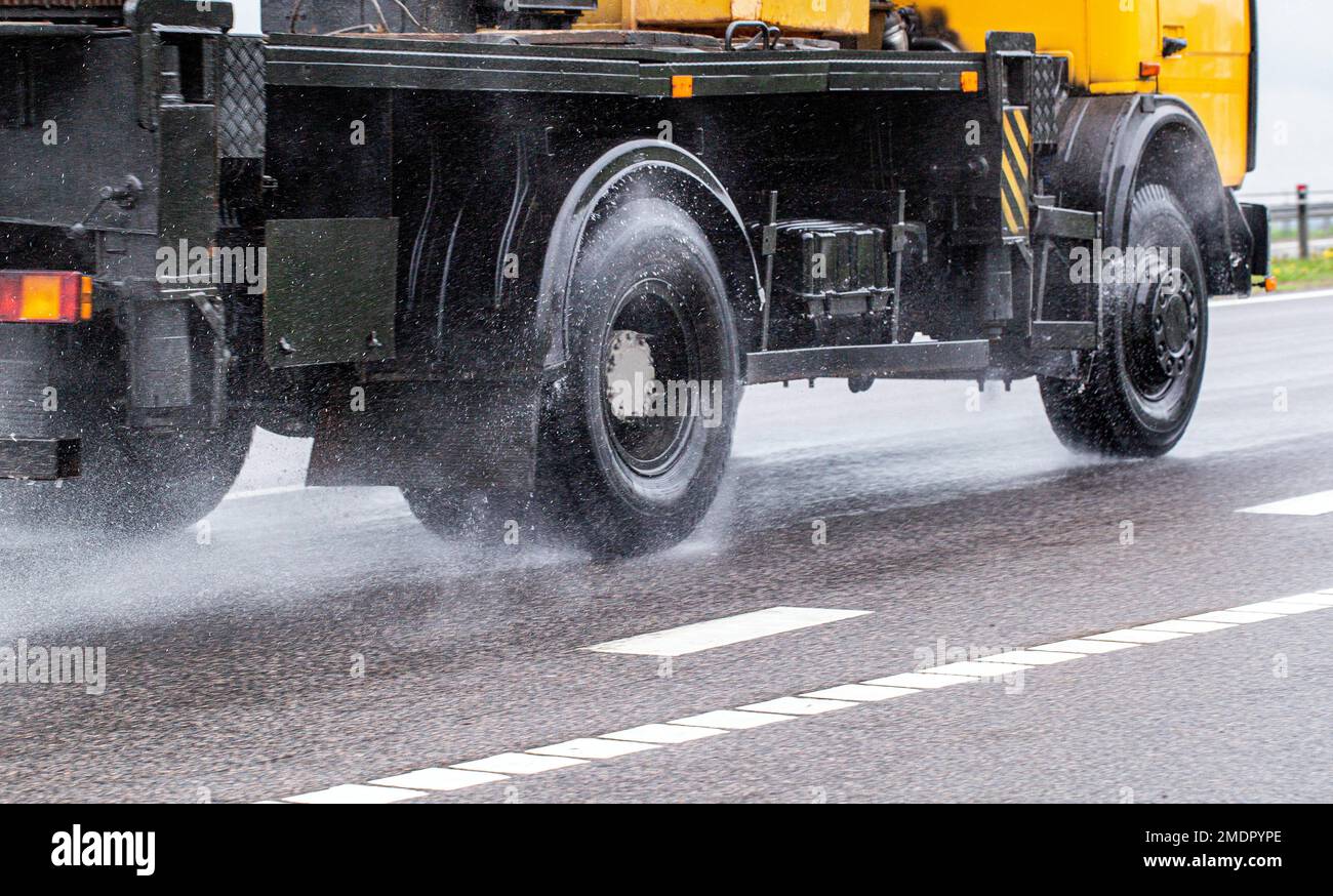 Truck tire grip with wet asphalt on the road. Slippery road Stock Photo ...