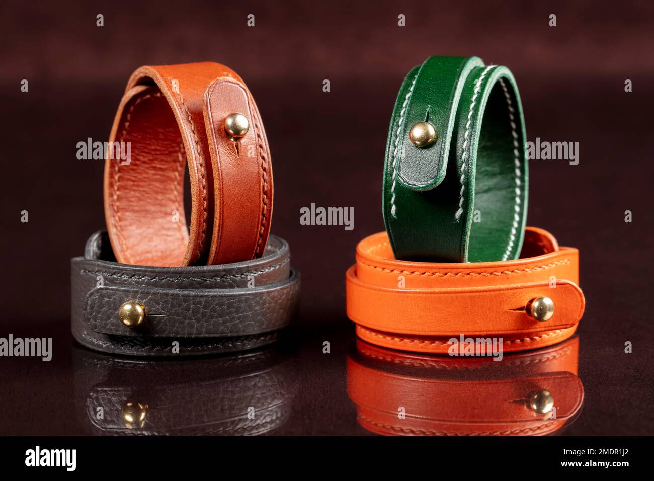 Leather bracelets with metal details on a dark background Stock Photo ...