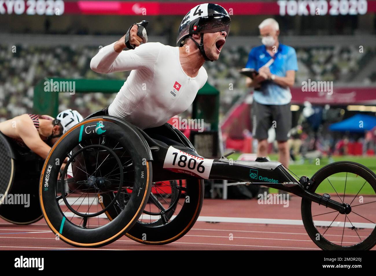 Switzerland's Marcel Hug celebrates after winning the men's T54 5000 ...