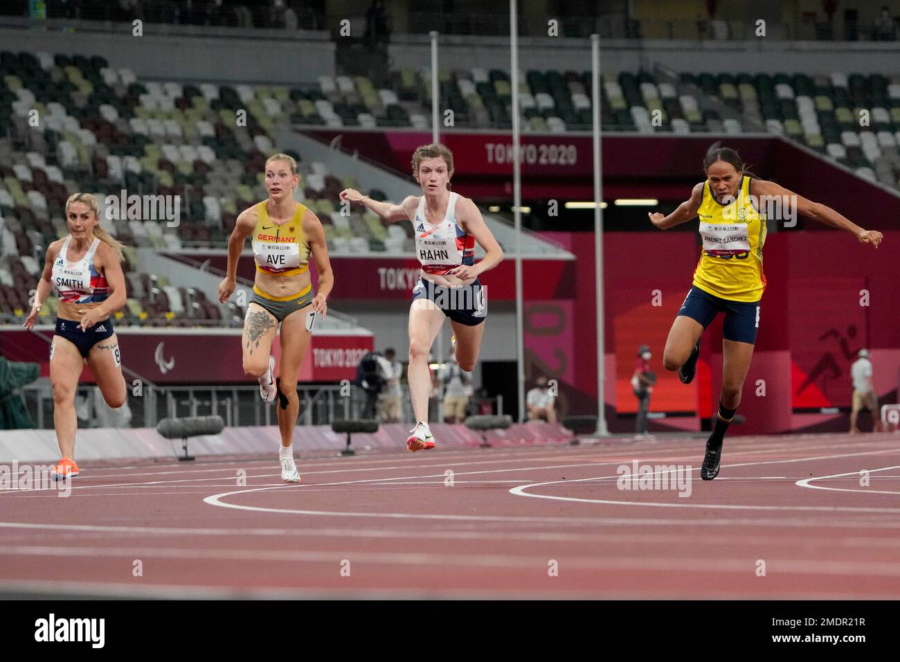 Britain's Sophie Hahn, centre, crosses the finish line to win the women ...