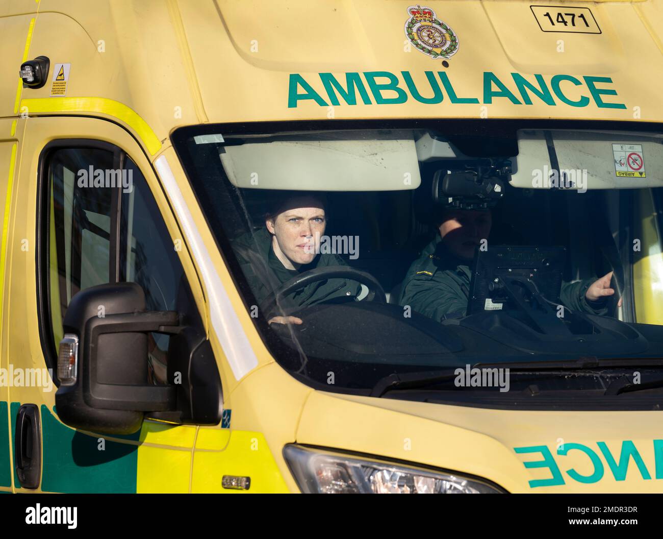 An ambulance worker responds to a call from the picket line outside ...
