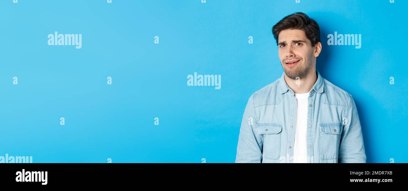 Confused and uncomfortable man looking at something strange or creepy ...