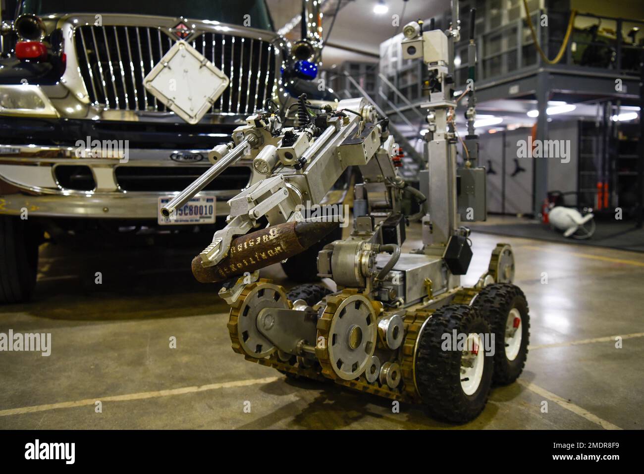 A U.S. Air Force F6 Andros robot holds an old unexploded ordnance at ...