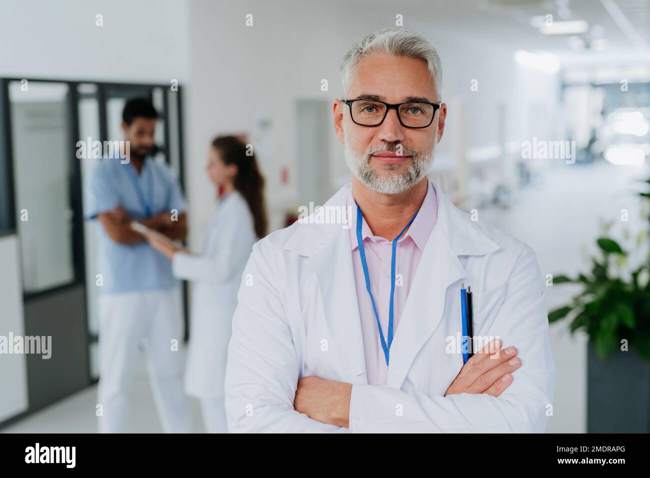 Portrait of happy doctor at hospital corridor Stock Photo - Alamy