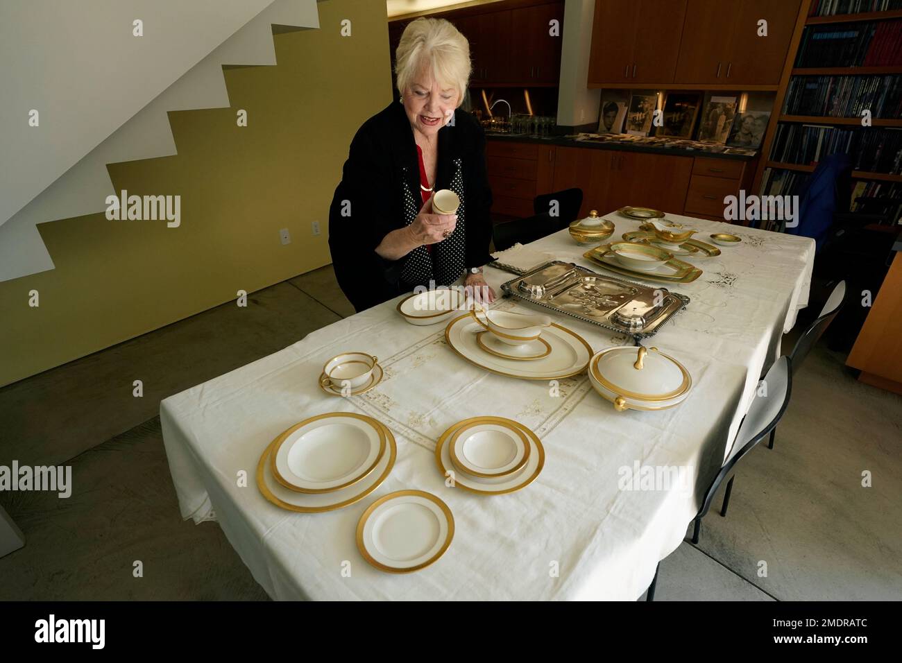 Diane Capone looks over one of the pieces of a china set that once ...