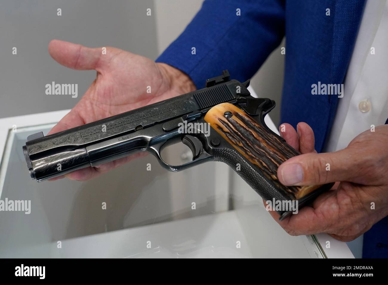 Brian Witherell displays a Colt .45-caliber pistol that once belonged ...