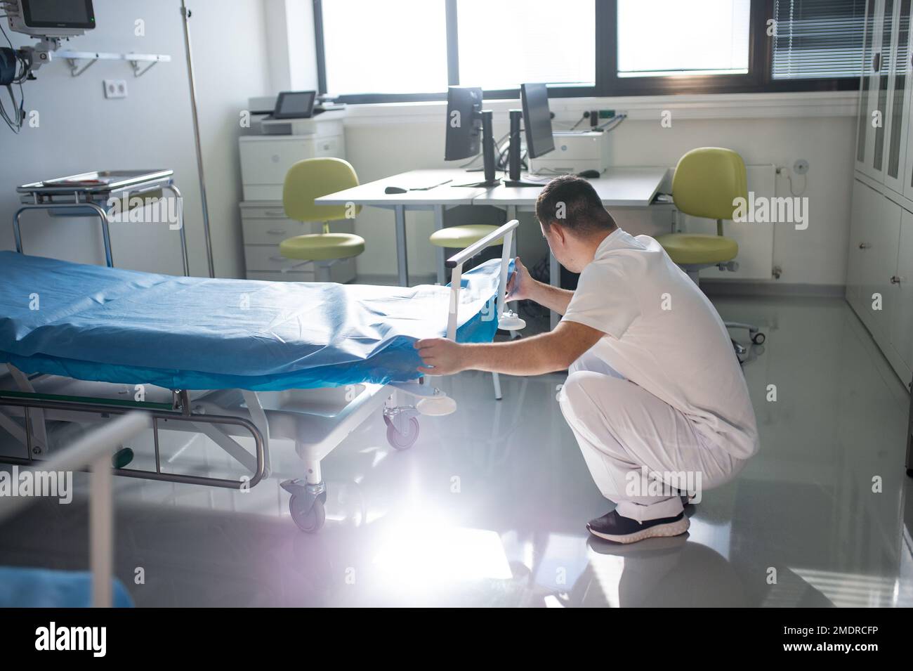 Young man with down syndome working in hospital as helper, cleaner ...