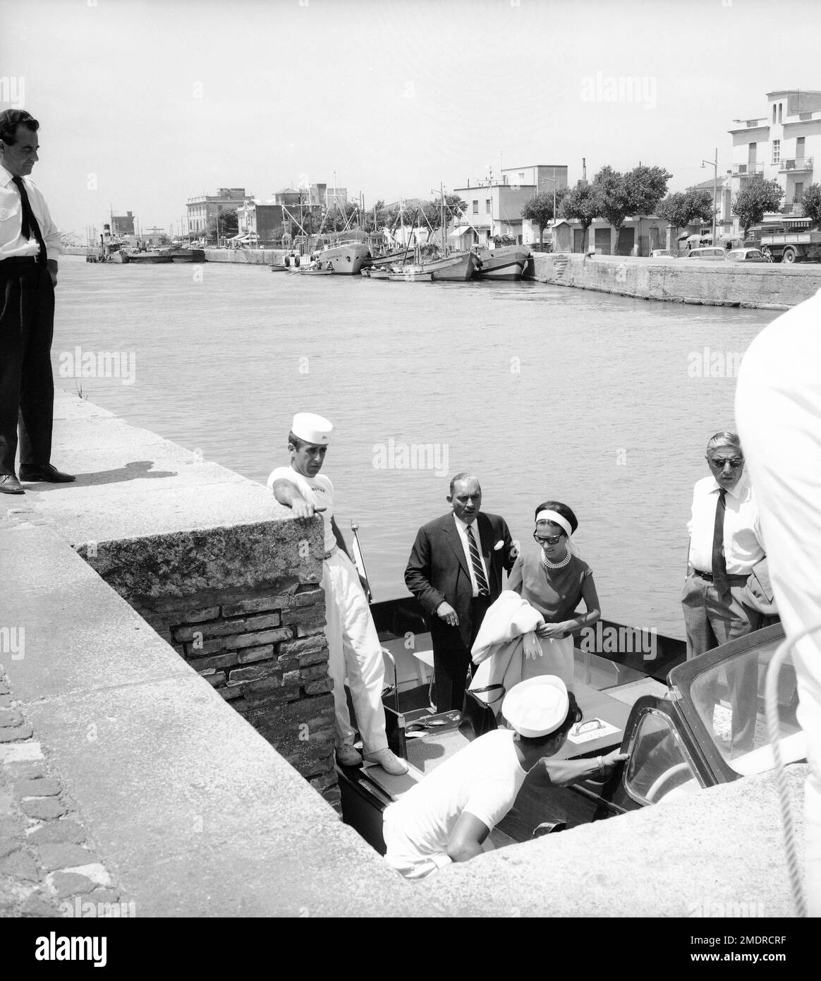 Greek shipping tycoon Aristotle Onassis, extreme right, glasses, stands ...