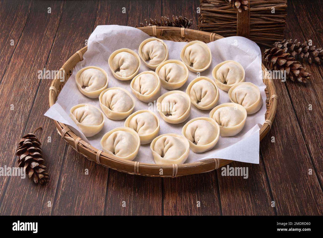 Korean handmade dumplings. Kimchi dumplings in a basket before roasting ...