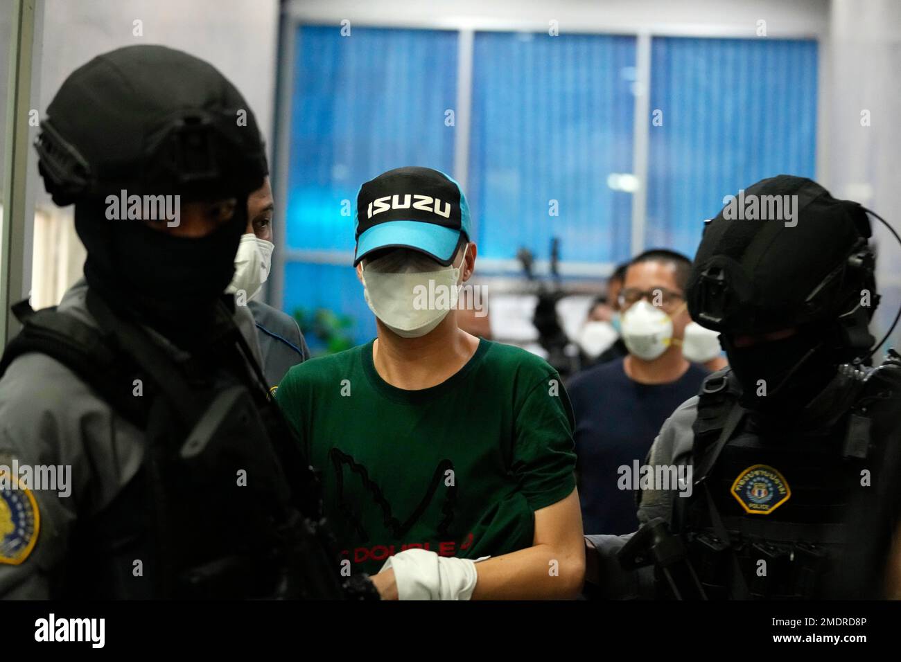 Thai police escort the former police officer Thitisan Utthanaphon ...