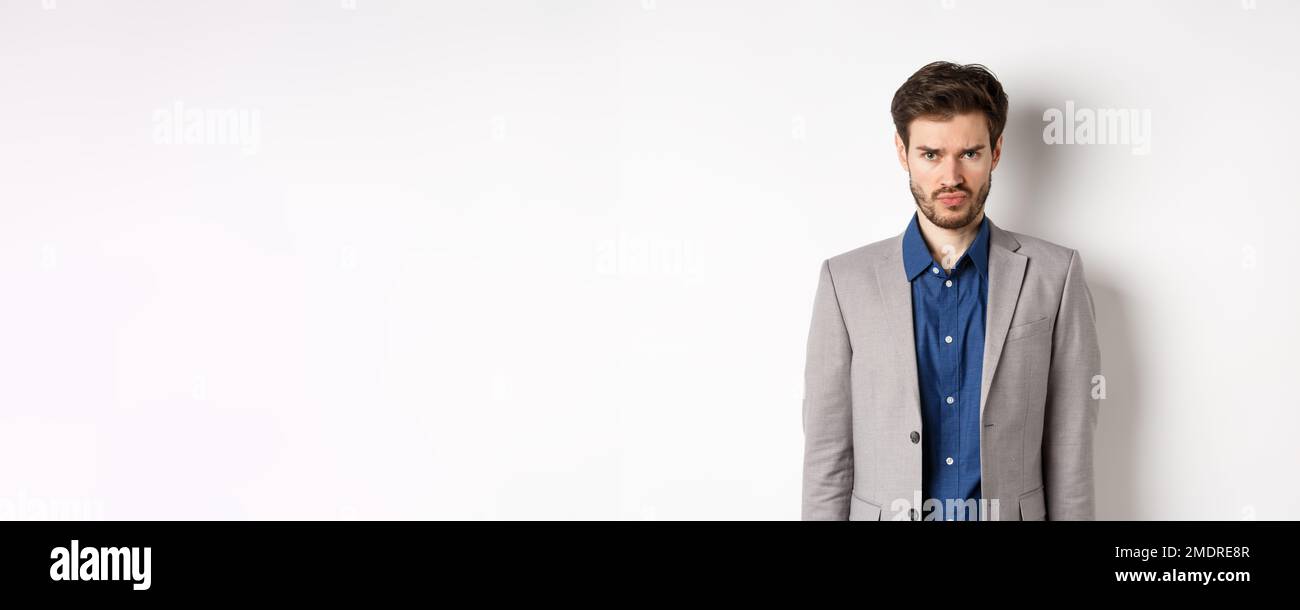 Sad offended guy sulking, wearing business suit, feel something unfair ...