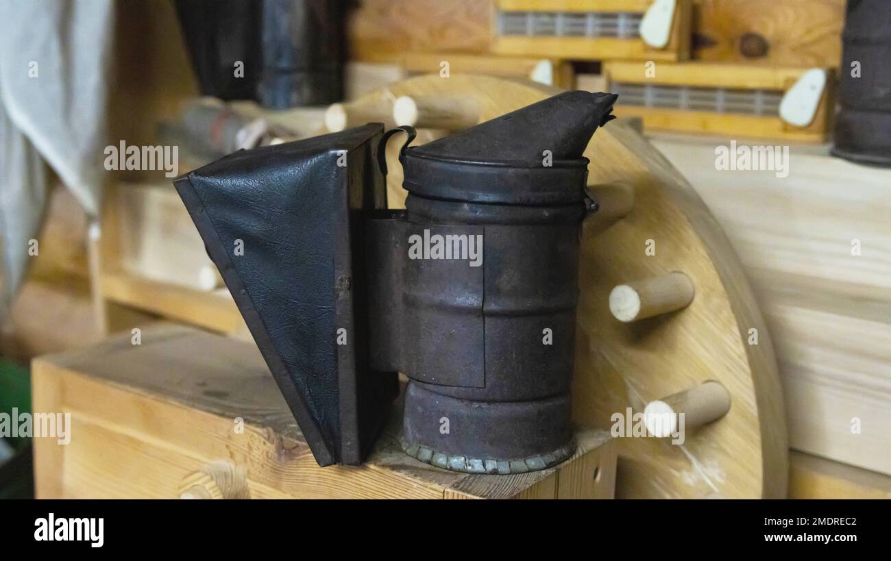 smoker for bees on a wooden background. Breeding bees and extracting ...