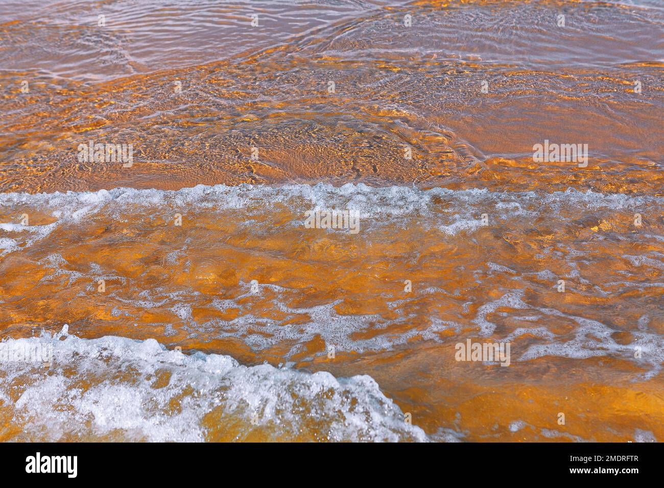 Ocean transparent water with foam . Shallow water waves Stock Photo - Alamy