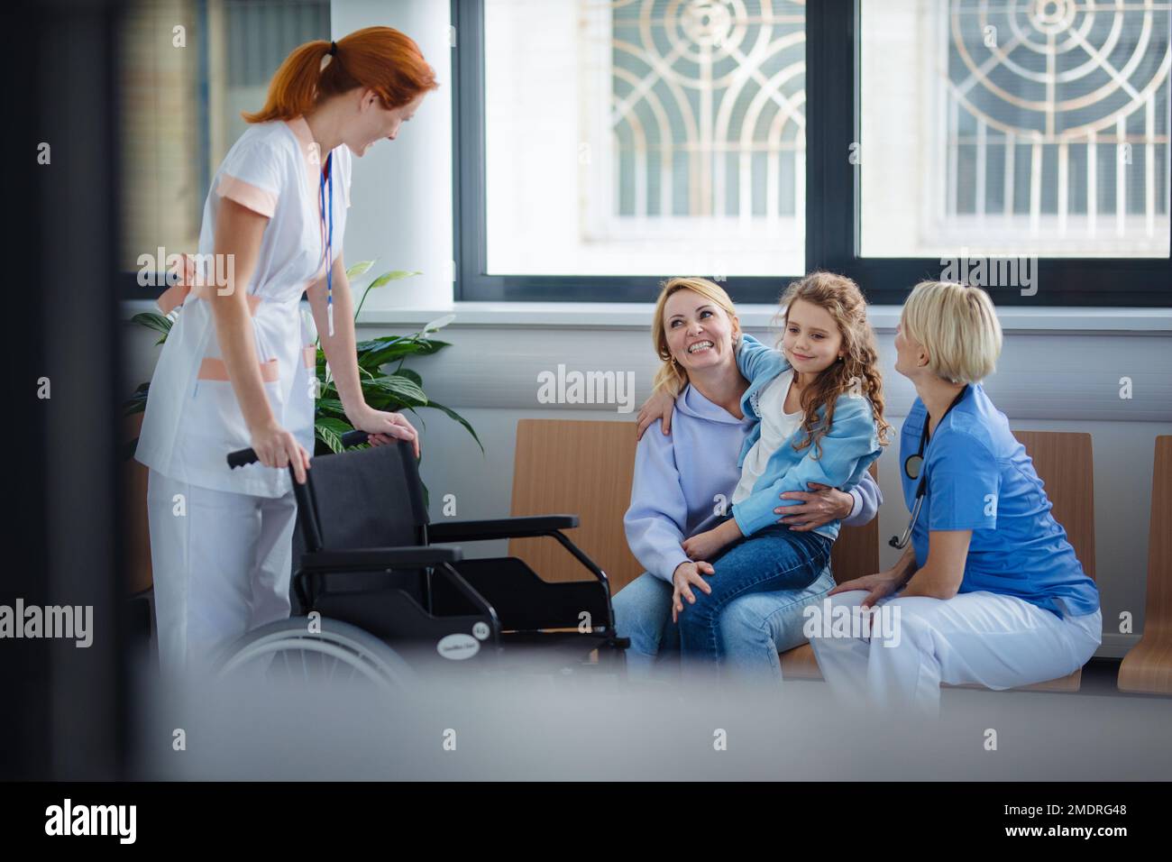 Little girl greeting with her mother in hospital, going home after ...