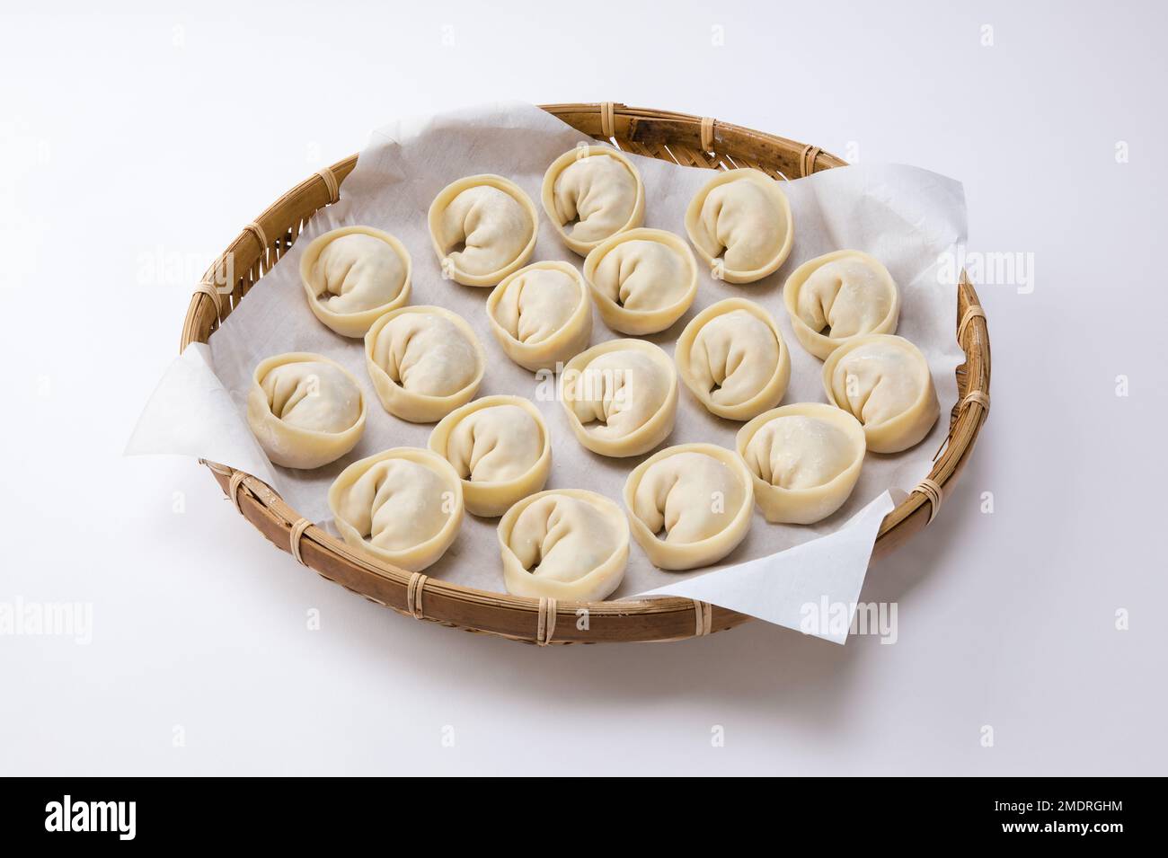 Korean handmade dumplings. Kimchi dumplings in a basket before roasting ...