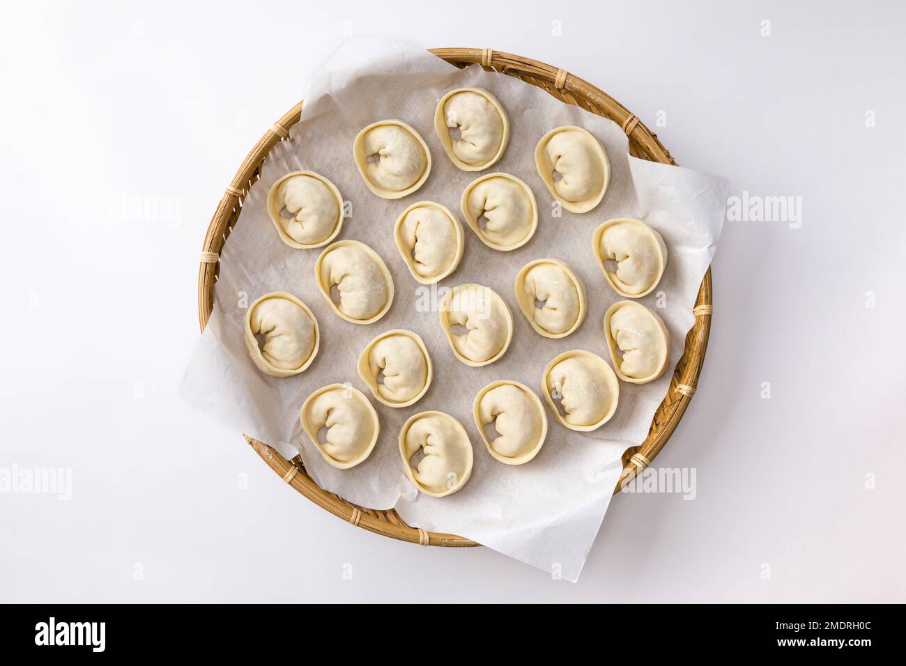 Korean handmade dumplings. Kimchi dumplings in a basket before roasting ...