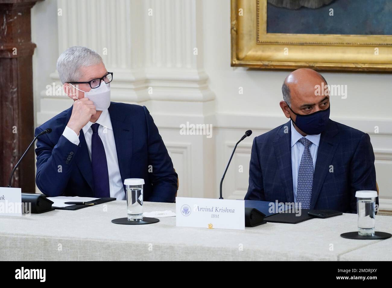 Apple CEO Tim Cook, left, and IBM CEO Arvind Krishna listen as ...