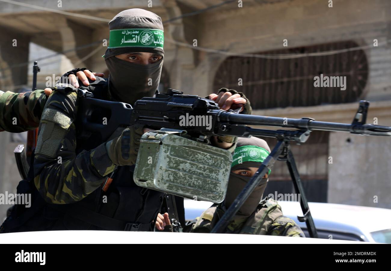 A masked militant from the Izzedine al-Qassam Brigades, a military wing ...