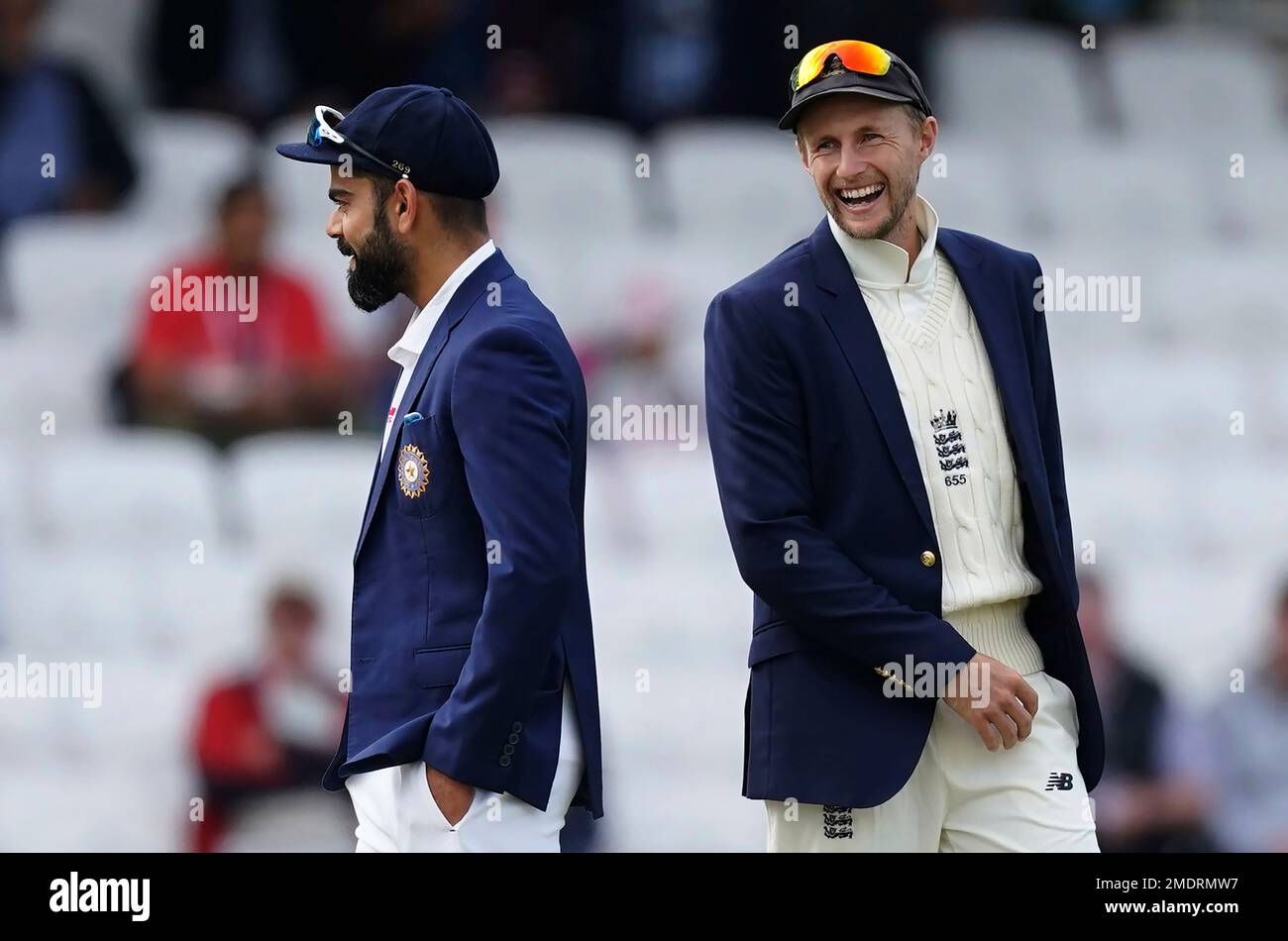 England captain Joe Root, right, laughs as he walks past India's ...