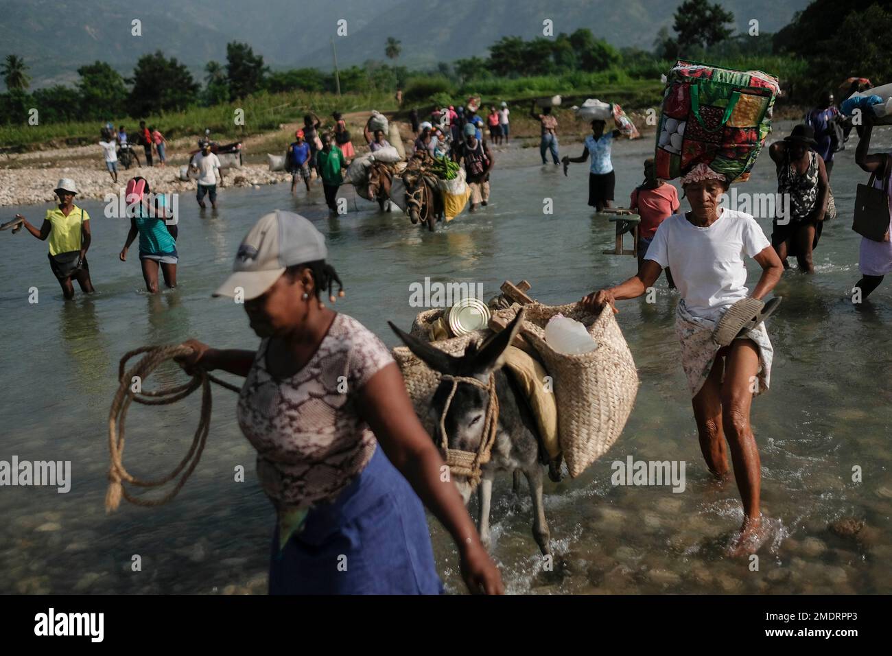 Residents cross the Cavaillon River to reach the Maniche market to sell ...