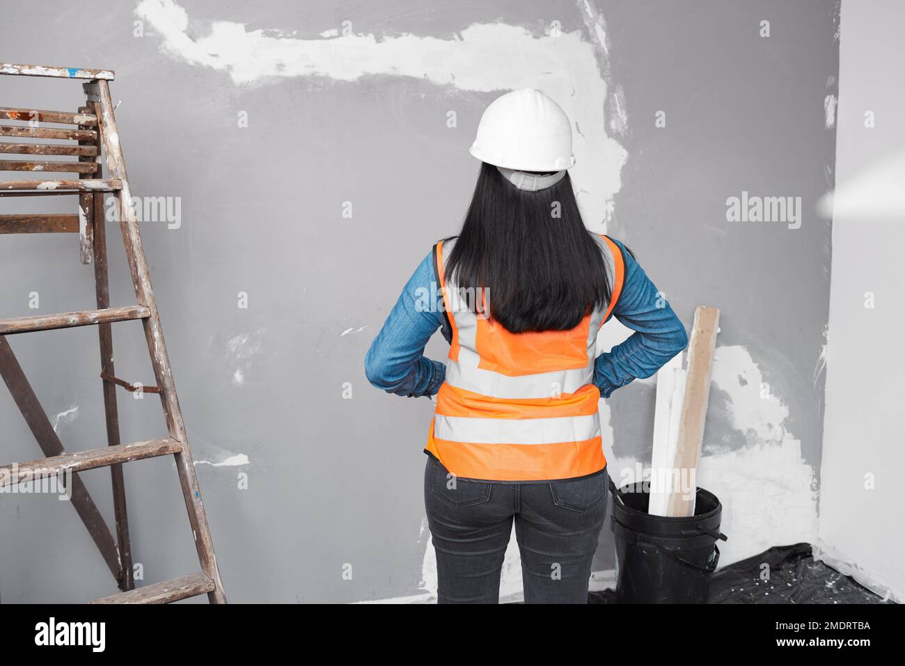 The back of a construction worker in uniform as she faces work in progress Stock Photo - Alamy