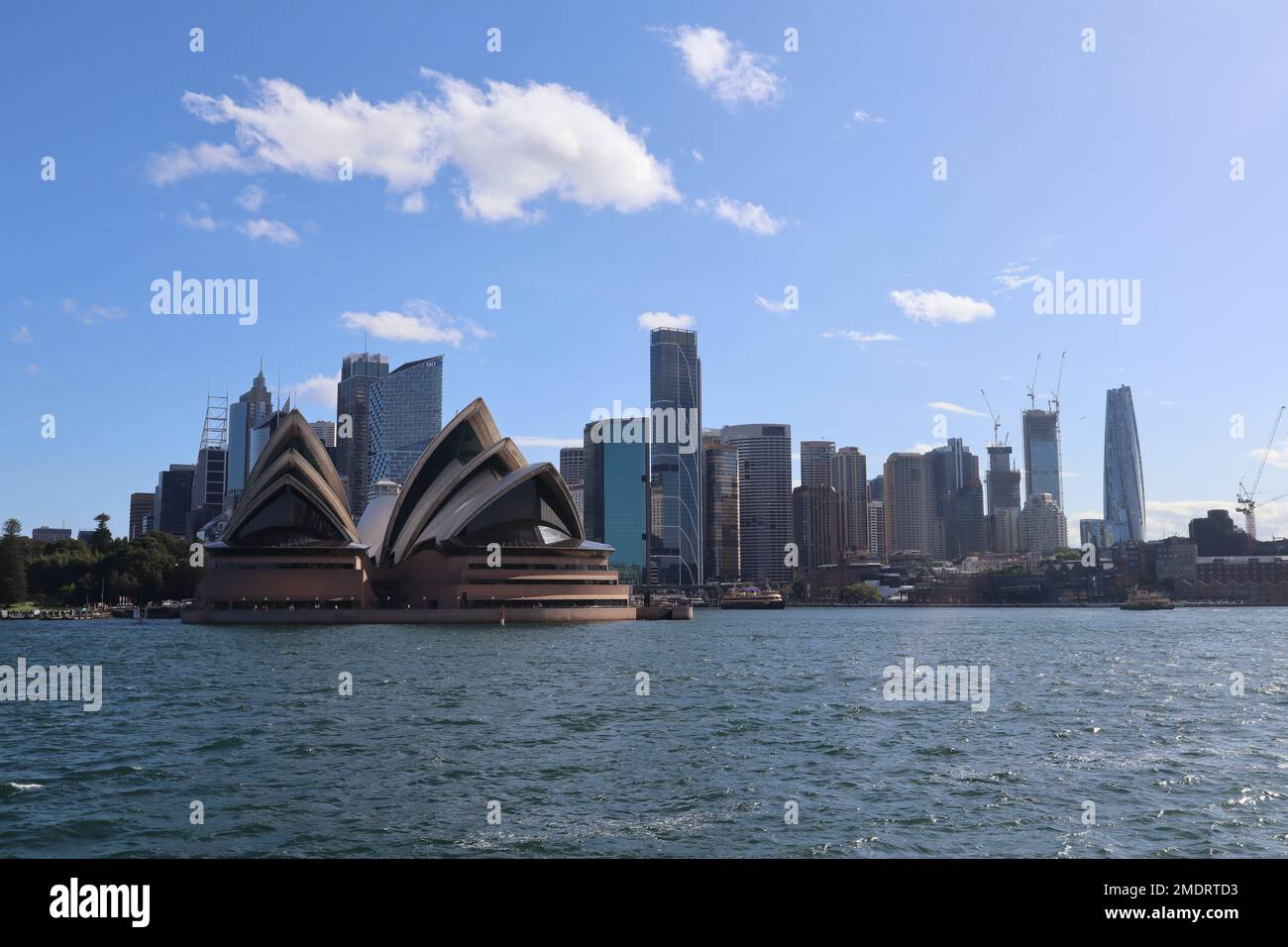 The blue sky over the Sydney Opera House with buildings at Circular ...