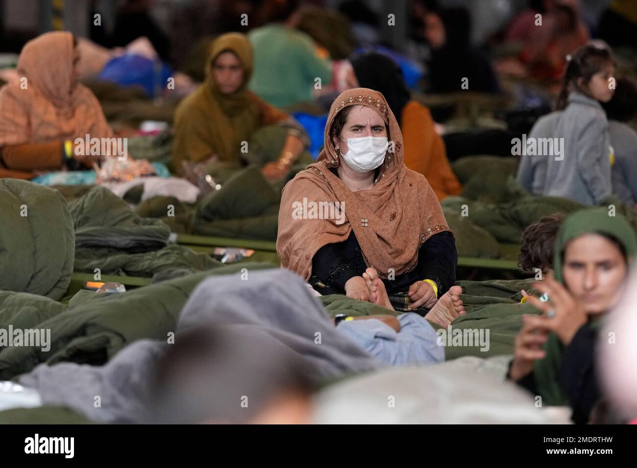A recently evacuated Afghan woman sits on a bench at the Ramstein U.S ...