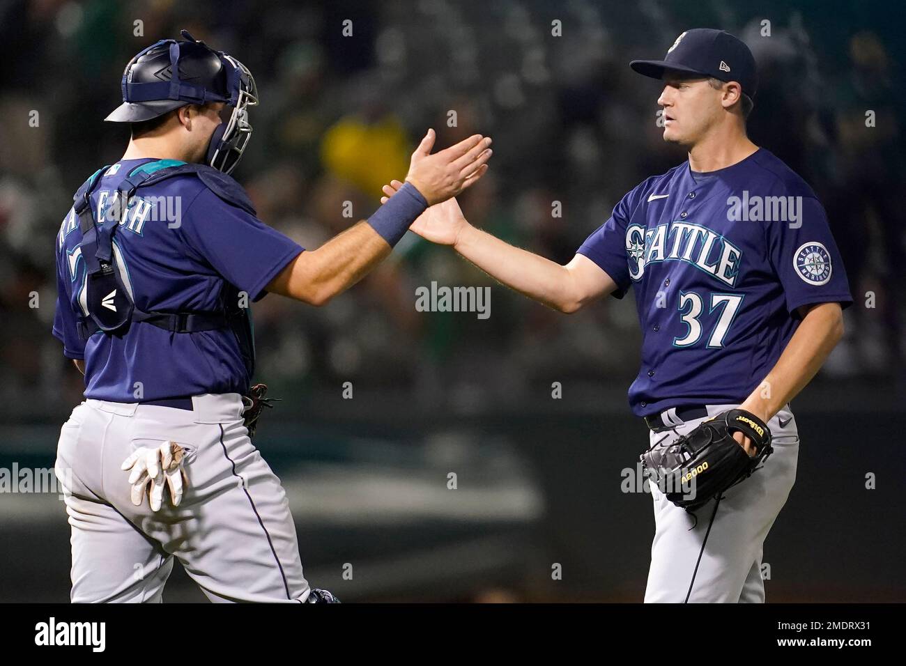 Seattle Mariners catcher Cal Raleigh, left, celebrates with pitcher ...