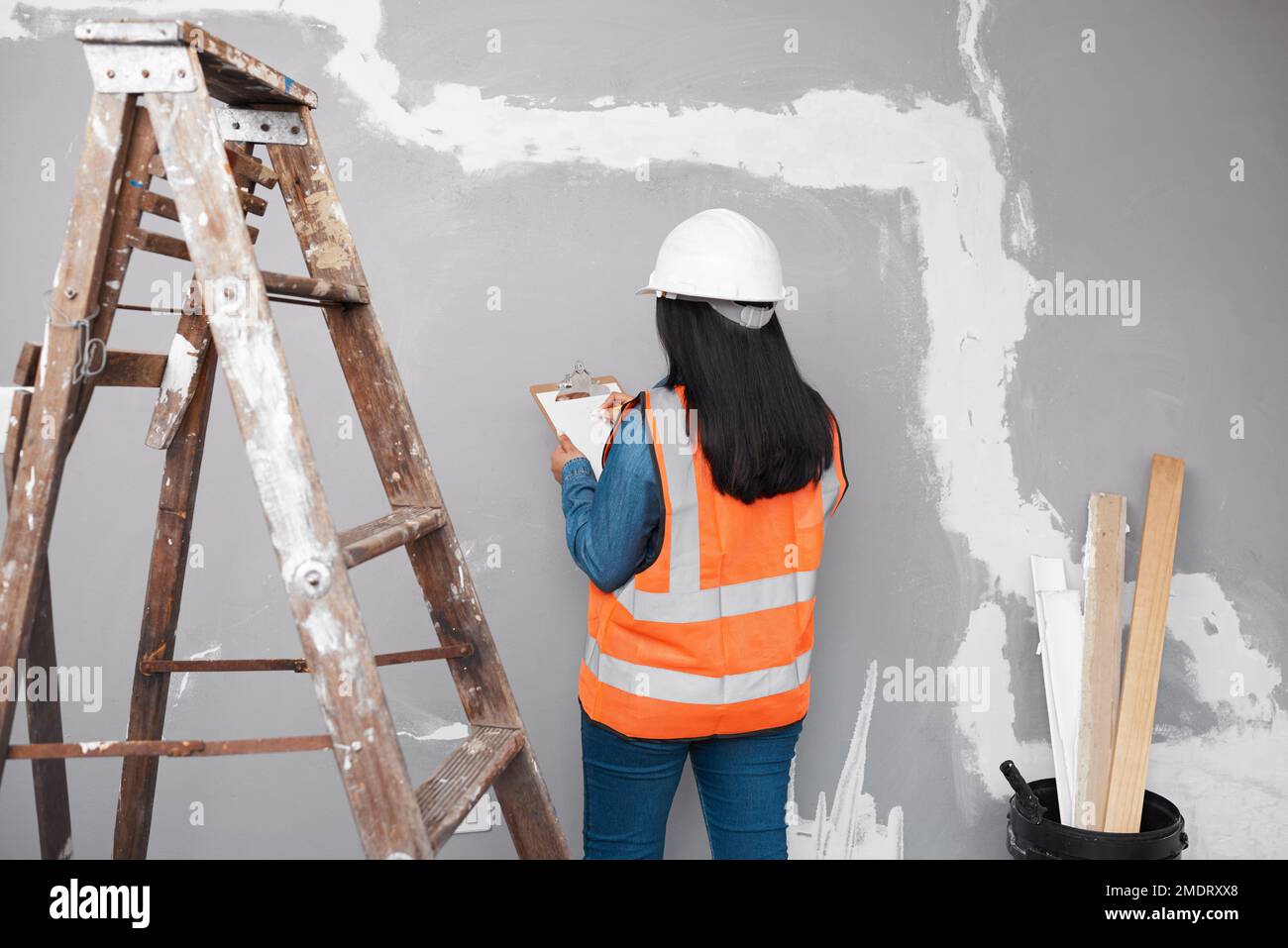 A construction supervisor checks renovation project with checklist on ...