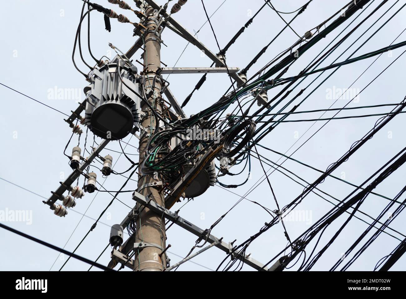 Mess of electric cables on the pole Stock Photo - Alamy