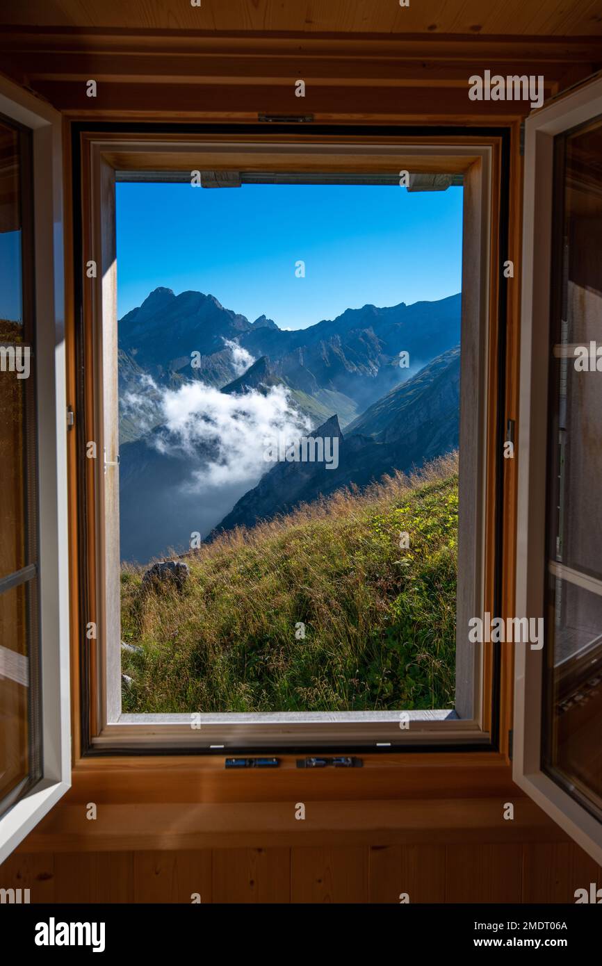 A mountain landscape photographed from a house, the window forms the ...