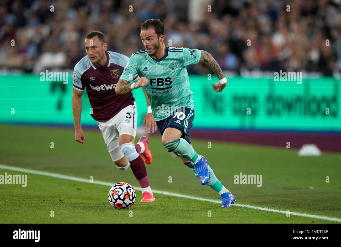 West Ham's Vladimir Coufal, left, chases Leicester's James Maddison ...