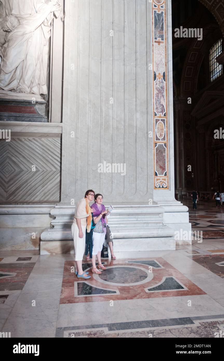 Mother and daughter looking up inside St Peter's Basilica, Vatican City ...