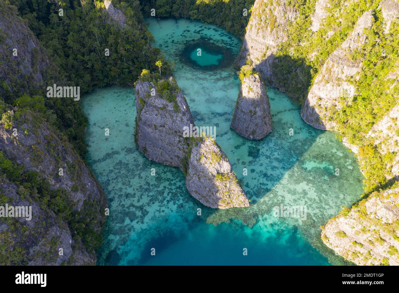 Rock islands, composed of limestone, rise from the tropical seascape in ...