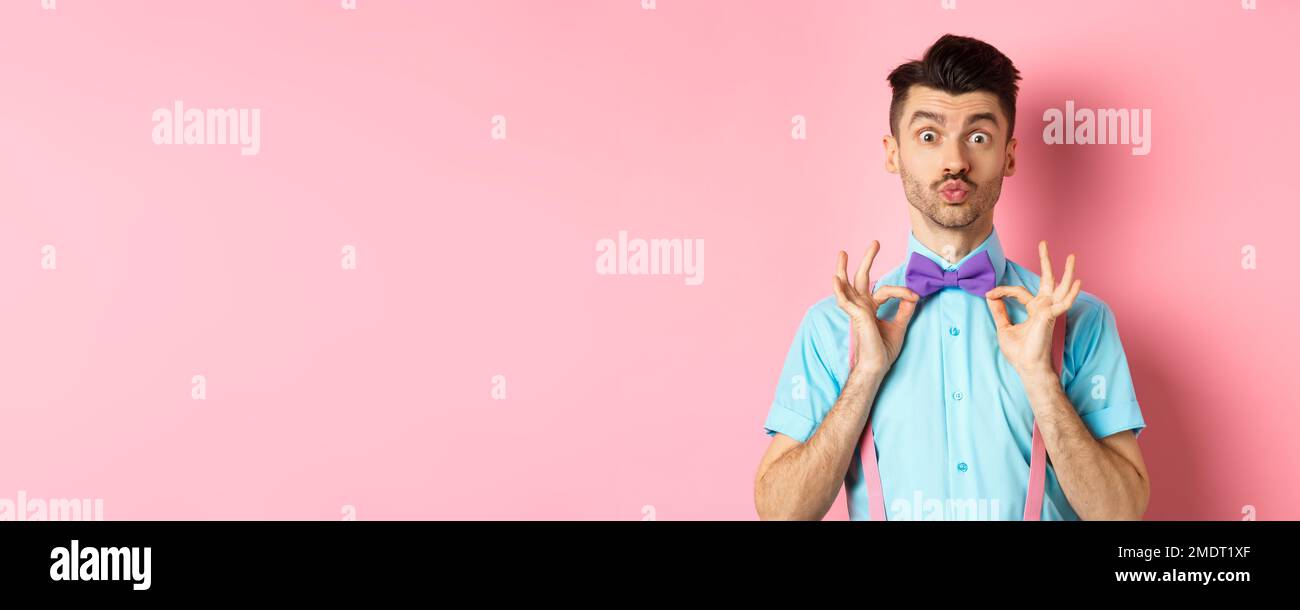Handsome and funny young man pucker lips for kiss, showing his classy ...