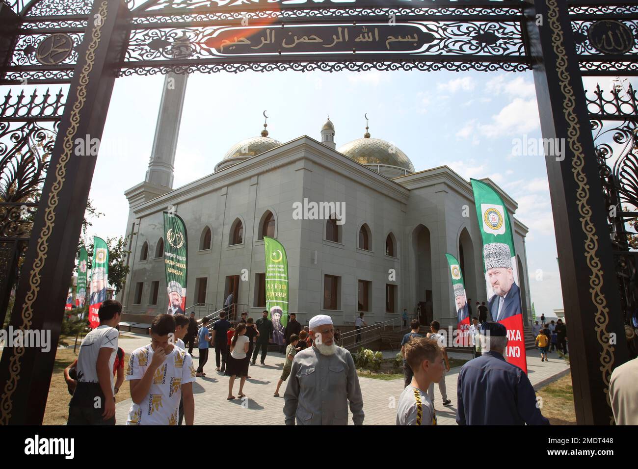 Chechen people walk outside the new mosque named after the first imam ...