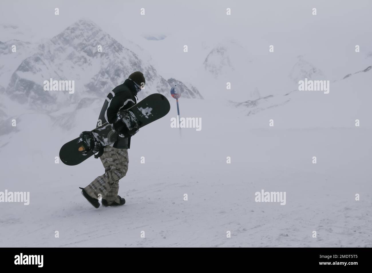 Snowboarding and skiing trip to Alps, Austria. Cold and windy day, lots ...