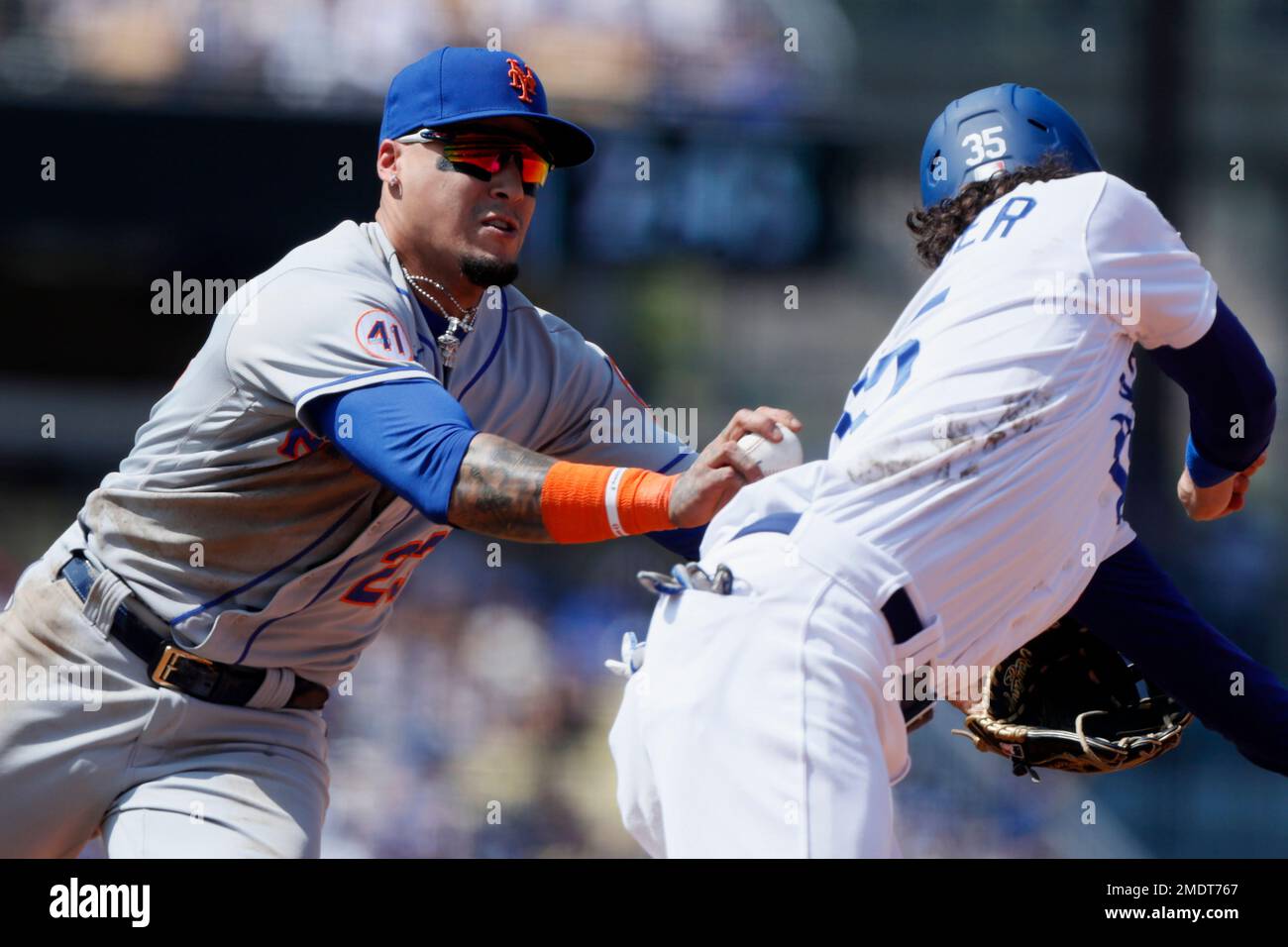 New York Mets shortstop Javier Baez, left, tags out Los Angeles Dodgers ...