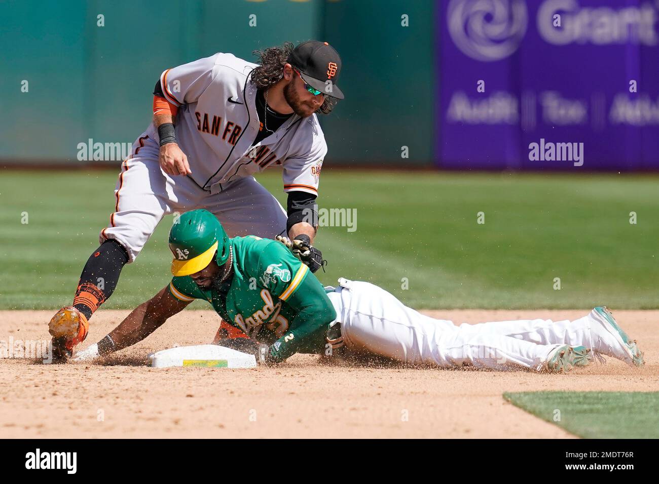 Oakland Athletics' Starling Marte, bottom, steals second base under San ...