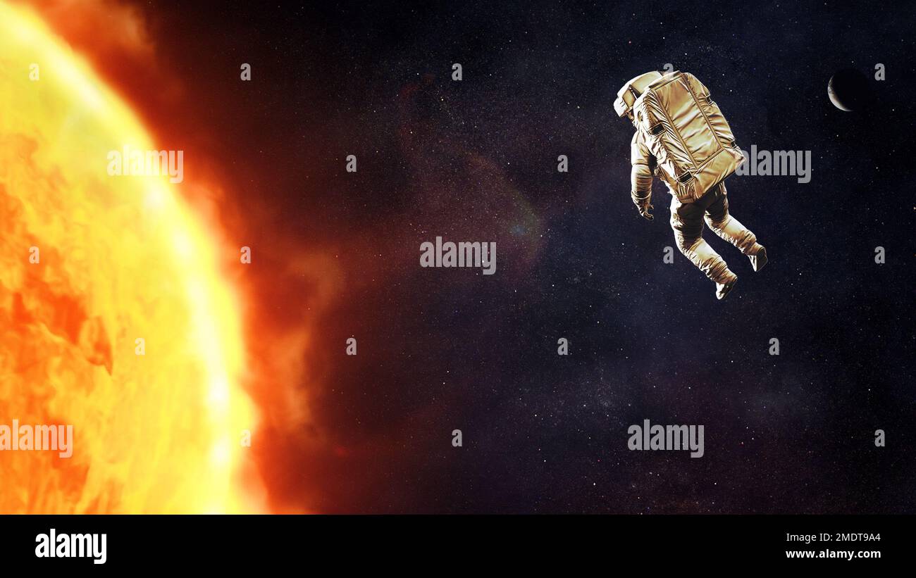 Cosmonaut floating in outer space next to the Sun. Elements of this ...