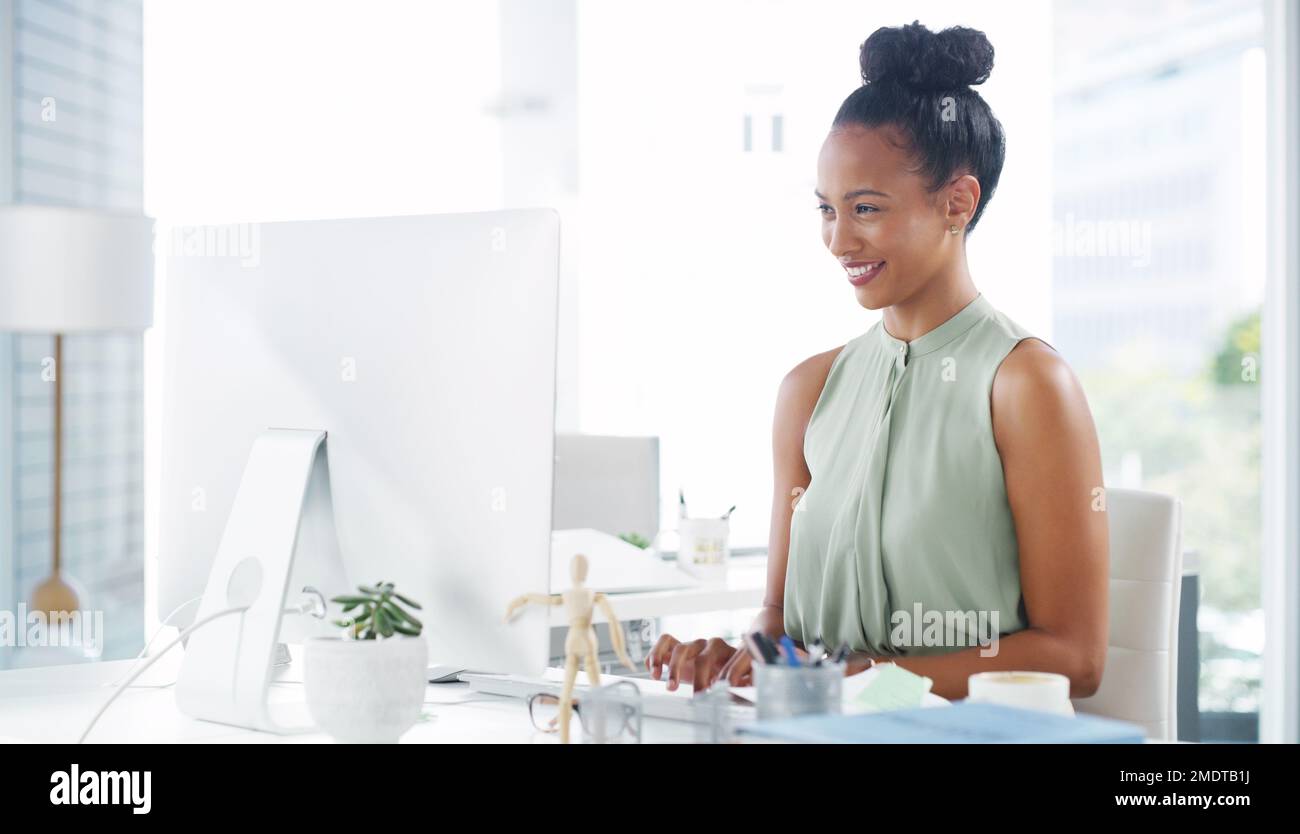 Happy days at the office. an attractive young businesswoman working at ...