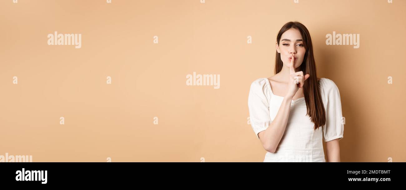 Sensual cute girl hiding secret, showing hush gesture, make shhh sound ...