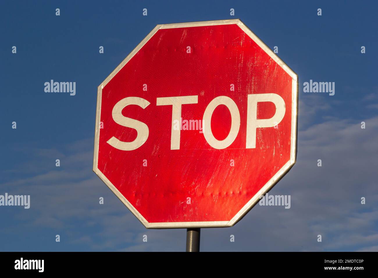 Red Stop Sign with Blue Sky and Clouds Background Stock Photo - Alamy