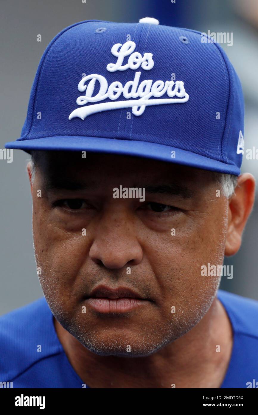 Los Angeles Dodgers' Dave Roberts walks in the dugout wearing a new Los ...