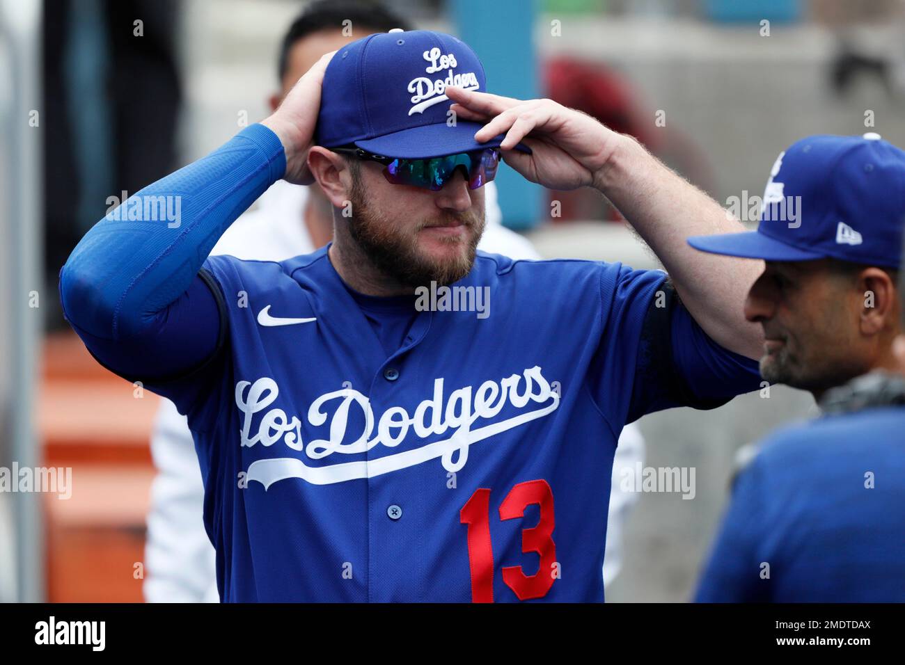 Los Angeles Dodgers' Max Muncy fixes his cap while wearing a new Los ...