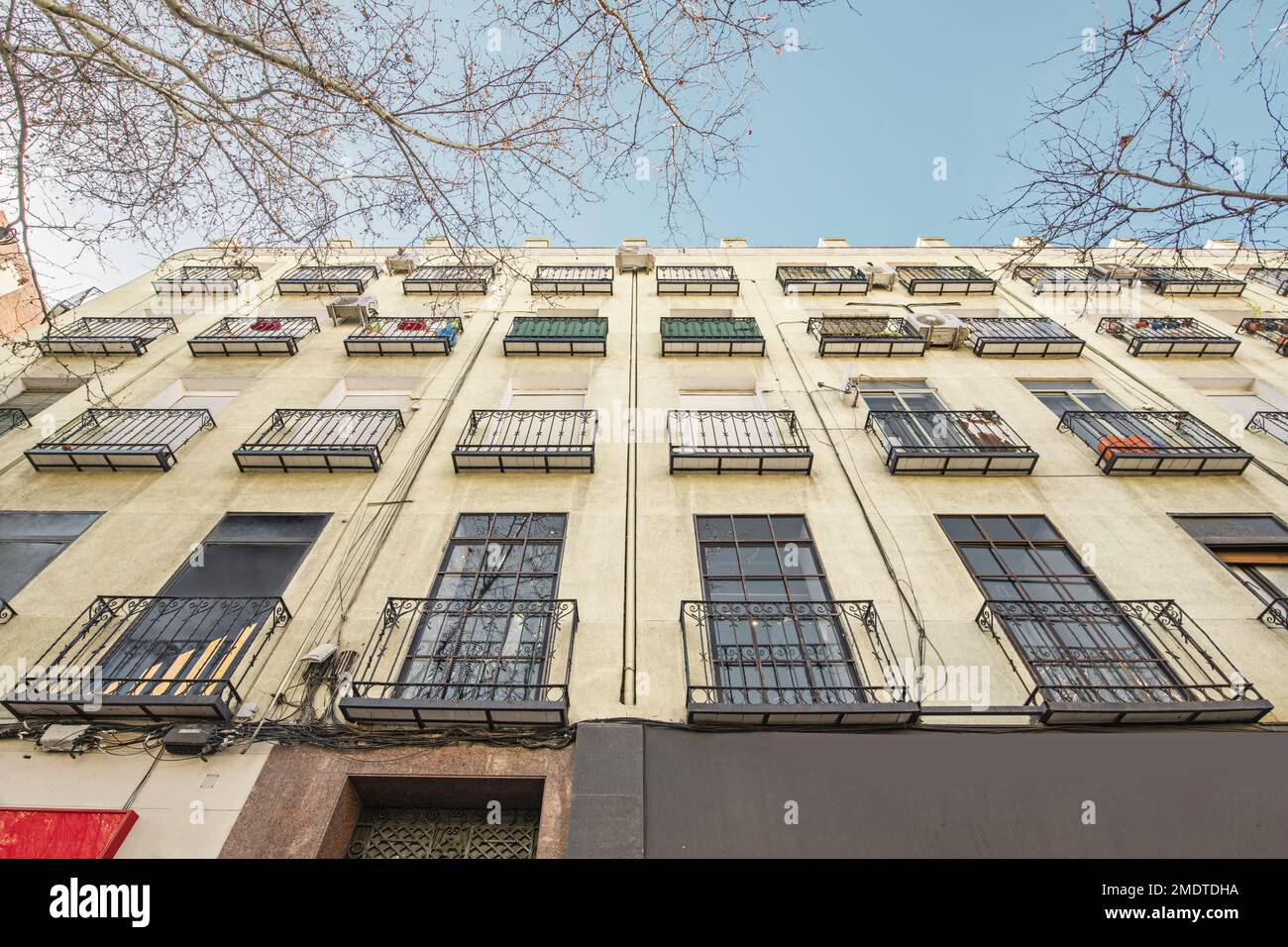 Low angle facade of a full facade building with many balconies and ...