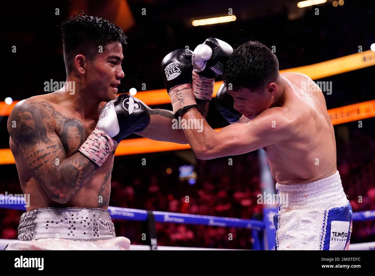 Mark Magsayo, left, of the Philippines, hits Julio Ceja, of Mexico, in ...