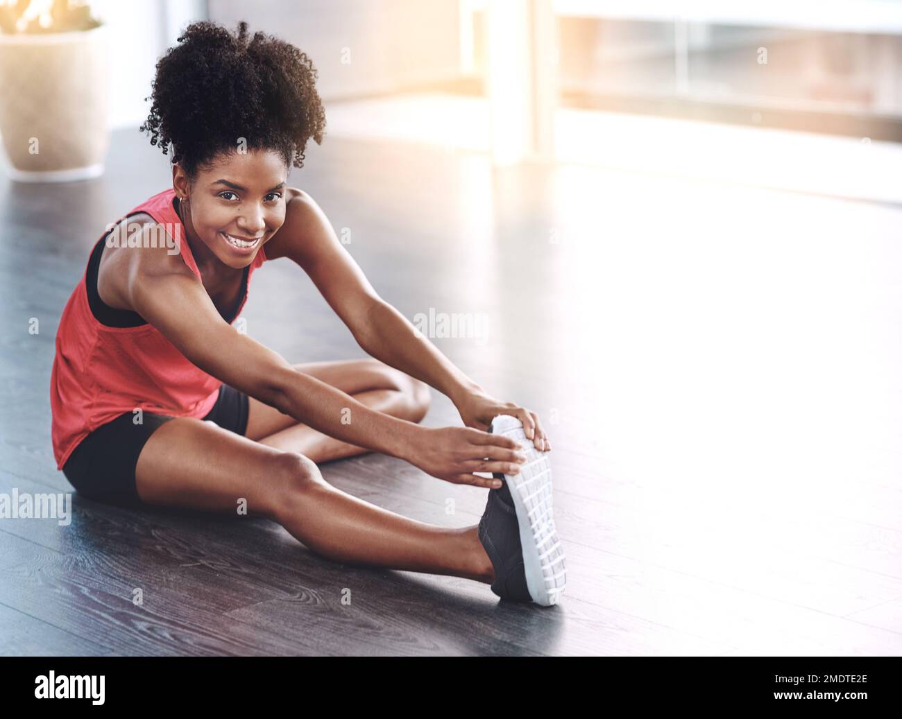 Improve your health with stretching regularly. a young woman doing ...