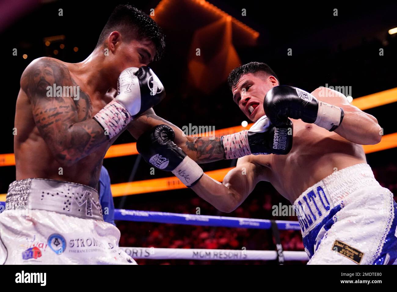 Mark Magsayo, left, of the Philippines, is ht by Julio Ceja, of Mexico ...